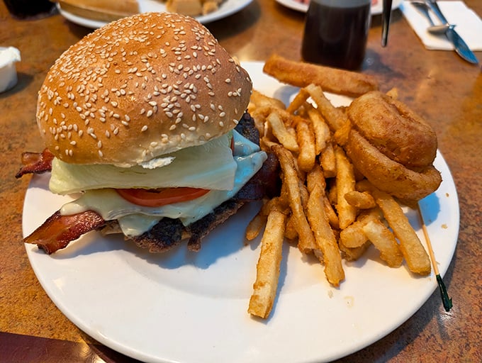 The classic diner cheeseburger—where sesame seeds meet destiny. Those golden fries aren't just a side; they're supporting characters in this lunch drama.