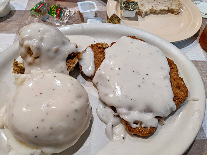 Country fried steak swimming in gravy so good you'll want to request a straw. The mashed potatoes aren't just a side—they're an essential life experience.