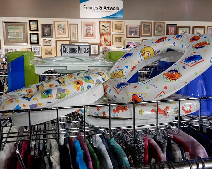 Sesame Street swim rings hanging above tiny clothes—childhood nostalgia in every aisle. Today's impulse purchase is tomorrow's "remember when they were small enough for this?"