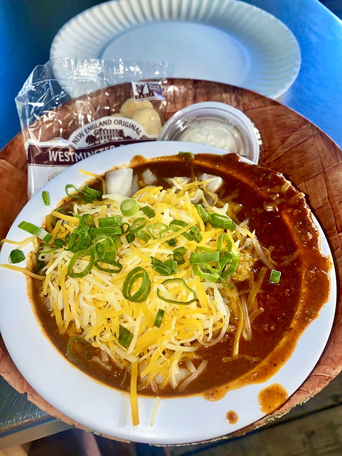 A bowl of chili topped with enough cheese to make Wisconsin proud—comfort food that hugs your insides like an old friend.