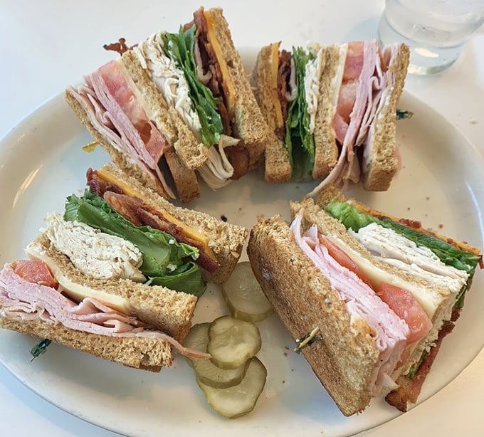 A club sandwich cut into quarters isn't just convenient—it's geometry and gastronomy holding hands and skipping through flavor town.