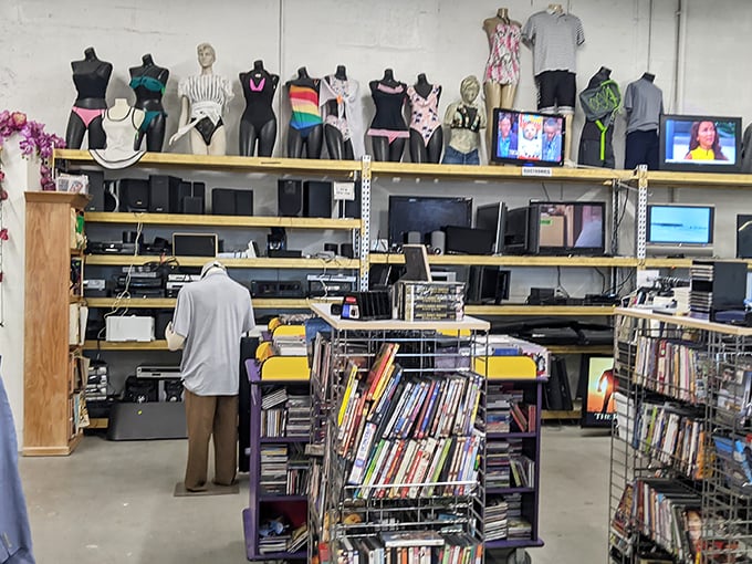 The electronics section proves one person's technological upgrade is another's perfect find. Those mannequins seem to be enjoying the show.