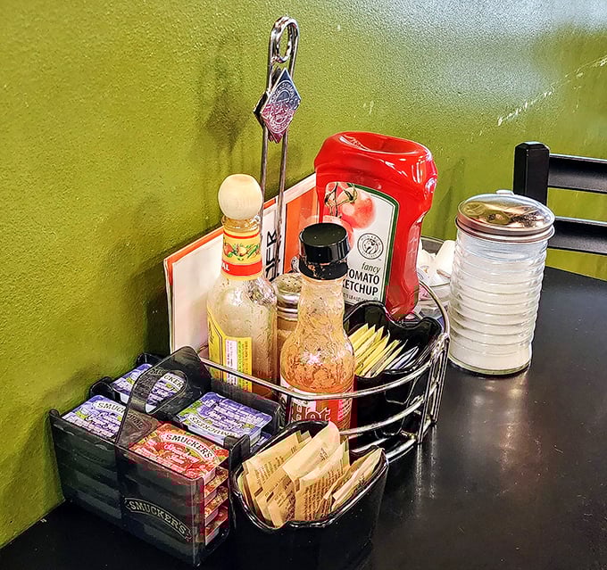 The condiment caddy—an unsung hero of breakfast establishments—stands ready to elevate your meal with hot sauce diplomacy.