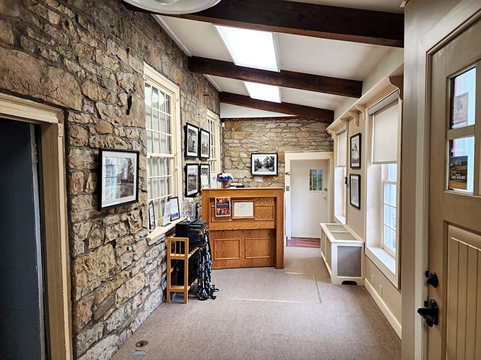 Exposed stone walls and historic photographs line this corridor, creating a time tunnel into Pennsylvania's roadside past.