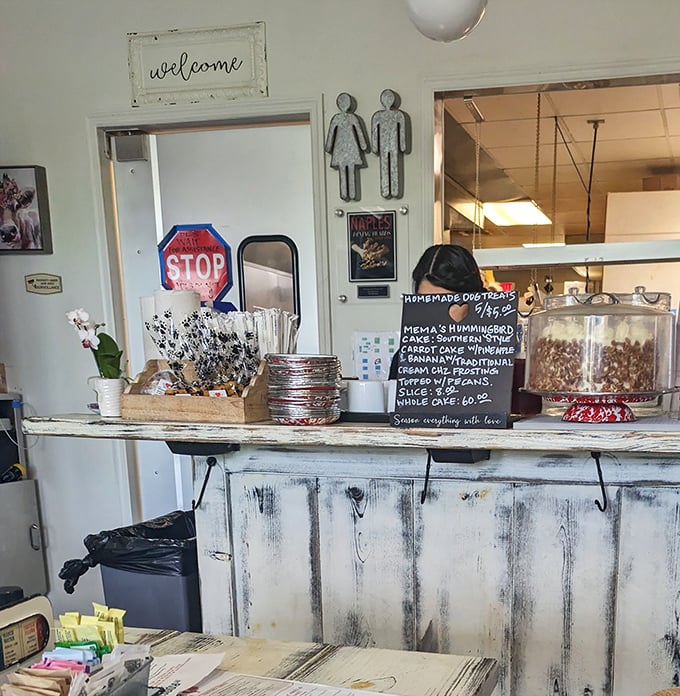 The counter area doubles as a dessert showcase. That "everything with love" sign isn't just cute decor—it's the restaurant's unofficial mission statement.