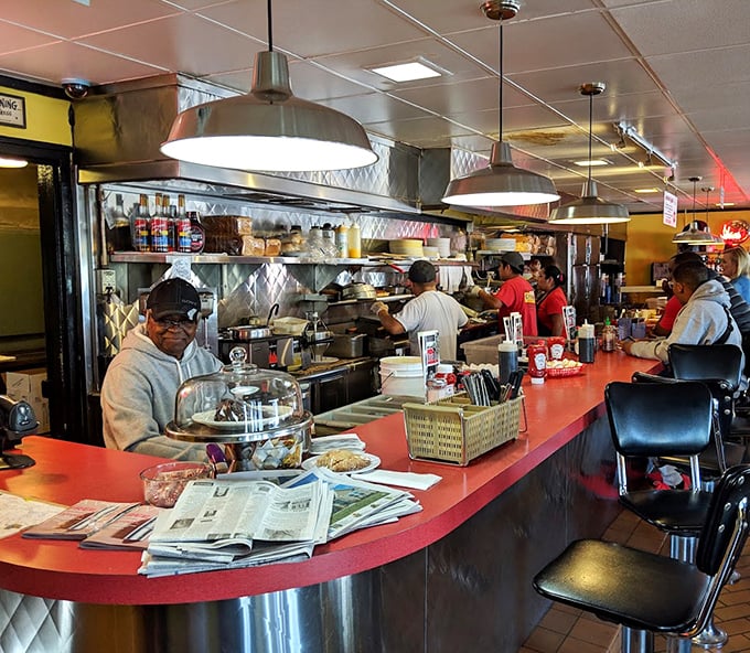 The counter—where solo diners find community, newspapers find purpose, and coffee cups never stay empty for long.