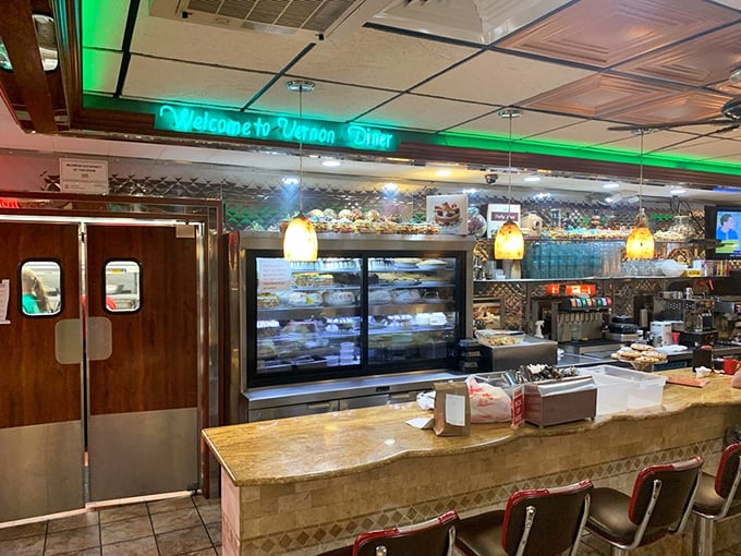 The counter area welcomes you with a neon "Welcome" sign—because even the lighting fixtures understand proper Connecticut hospitality.