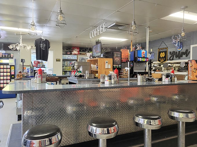 The counter where magic happens – classic diner stools inviting you to sit, stay awhile, and watch breakfast choreography in action.