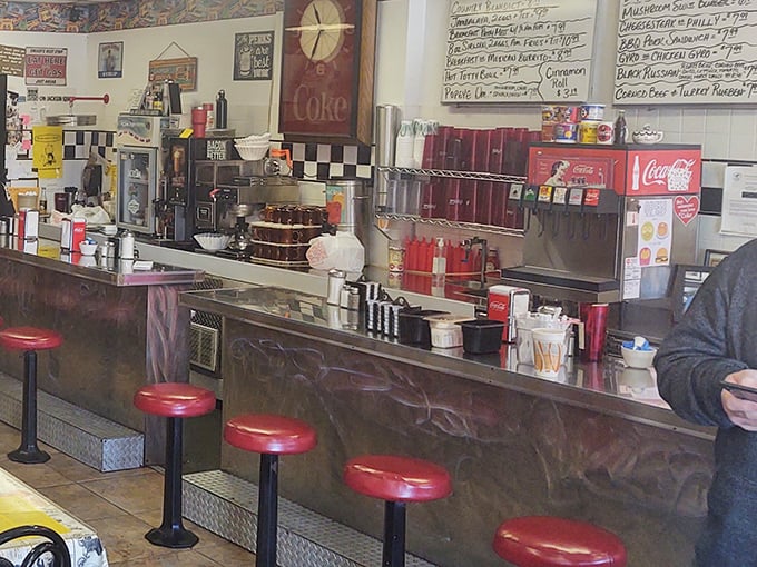 Classic diner counter seating – where solo diners become temporary neighbors and coffee cup emptiness is merely theoretical.