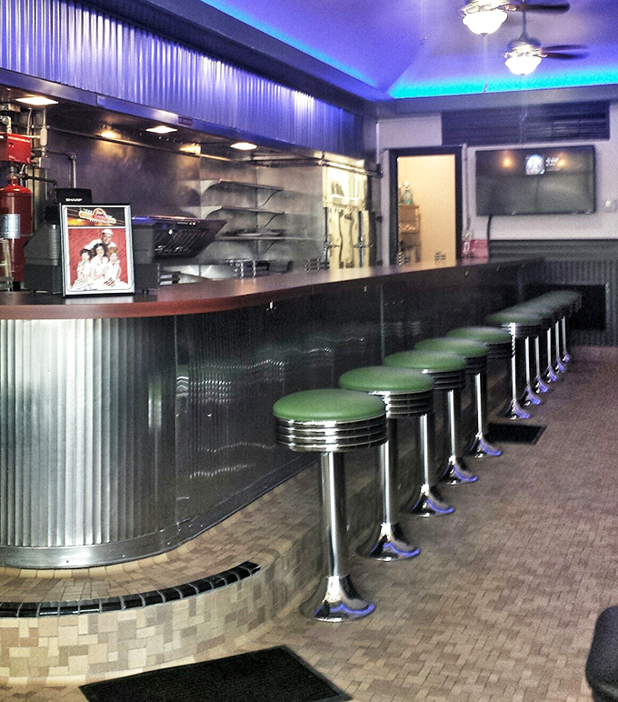 Classic counter seating with green vinyl stools—where solo diners never feel alone and the best diner tips are exchanged between strangers becoming friends.