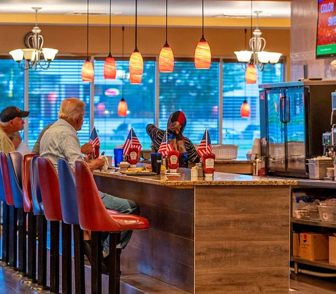 Counter seating where solo diners become part of the diner family, complete with American flags that remind you this is classic Americana at its finest.