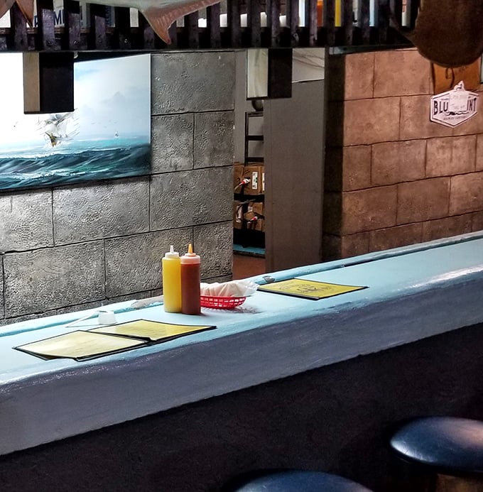 The blue counter—where oyster magic happens. This is the front-row seat to culinary theater, where skilled hands transform rough shells into briny delights.