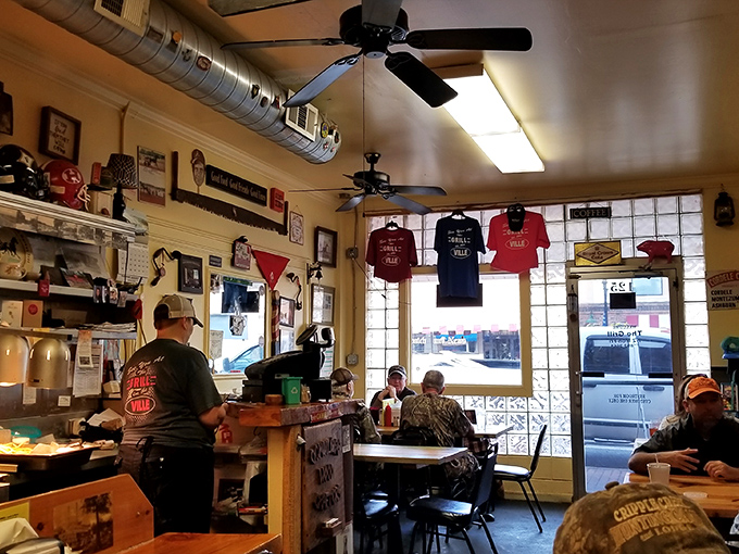 T-shirts hang like battle flags, ceiling fans spin lazily overhead, and every surface tells a story. This isn't decoration—it's a living museum of local pride.
