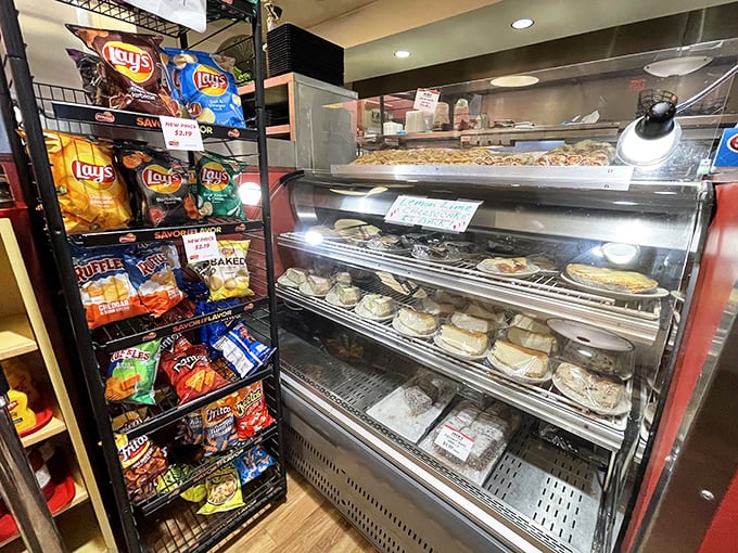 The dessert case stands guard like a sentry of sweetness, promising the perfect finale to your deli feast – calories worth every smile.