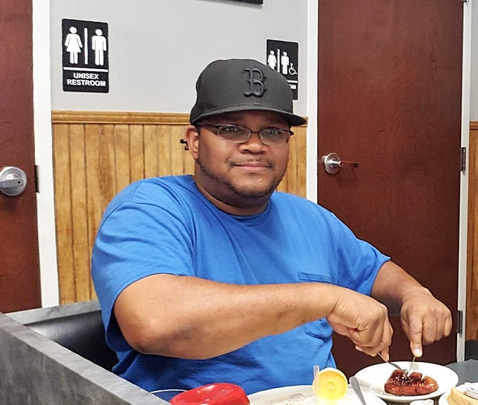 A person enjoying their meal – the universal expression of diner satisfaction. This is what happiness looks like at breakfast time.