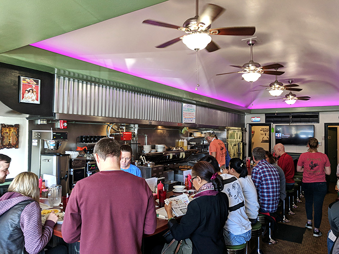 The counter seats—always the best real estate in any diner—filled with regulars and first-timers united by the universal language of good food.