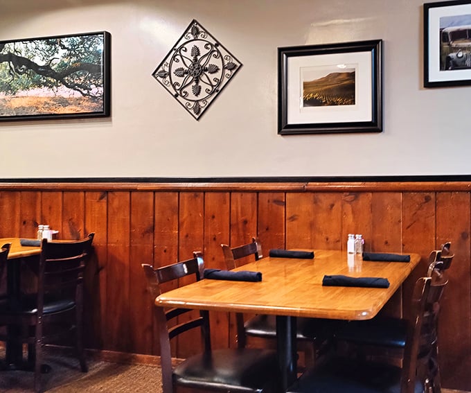 Simple tables, wood paneling, and framed landscapes—because when the steak is this good, you don't need distractions.