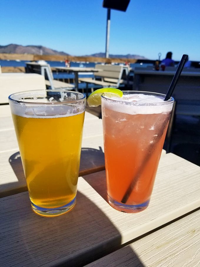 Cold beer and a sunset-colored cocktail—because hydration is important when you're busy solving the world's problems from a pier-side table.