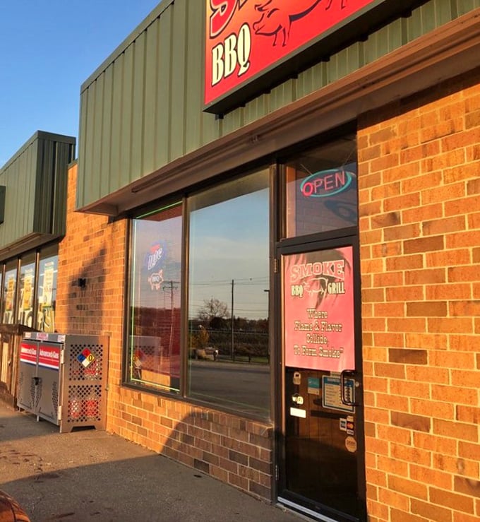 The entrance beckons with promises of smoky delights within. That neon "OPEN" sign might as well say "PARADISE FOUND" for BBQ lovers.