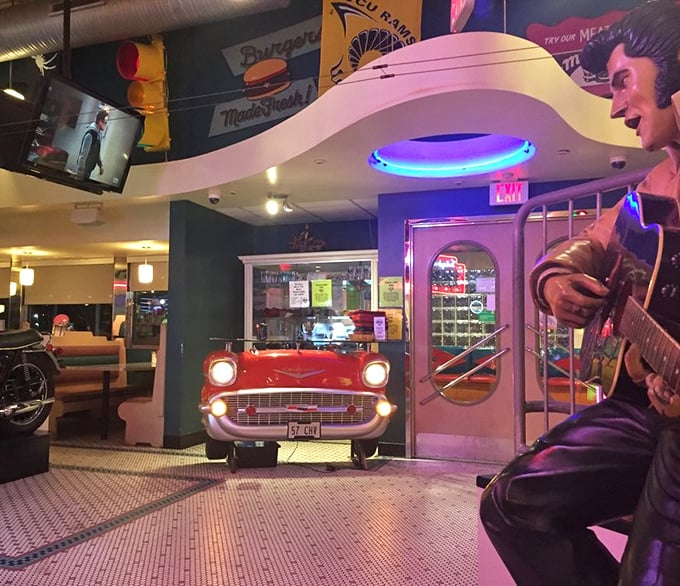 The retro interior features classic Americana touches like Elvis memorabilia and a vintage car front—proving nostalgia tastes better with good food.