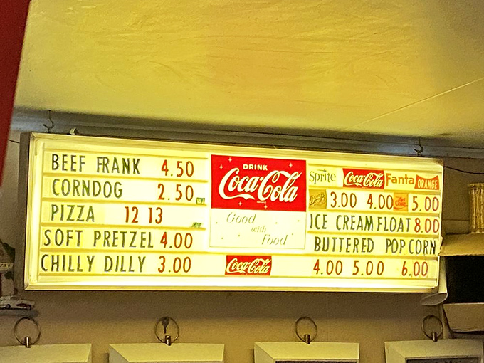 The illuminated menu board—a beacon of comfort food possibilities that makes choosing between a corndog and pizza life's biggest decision.