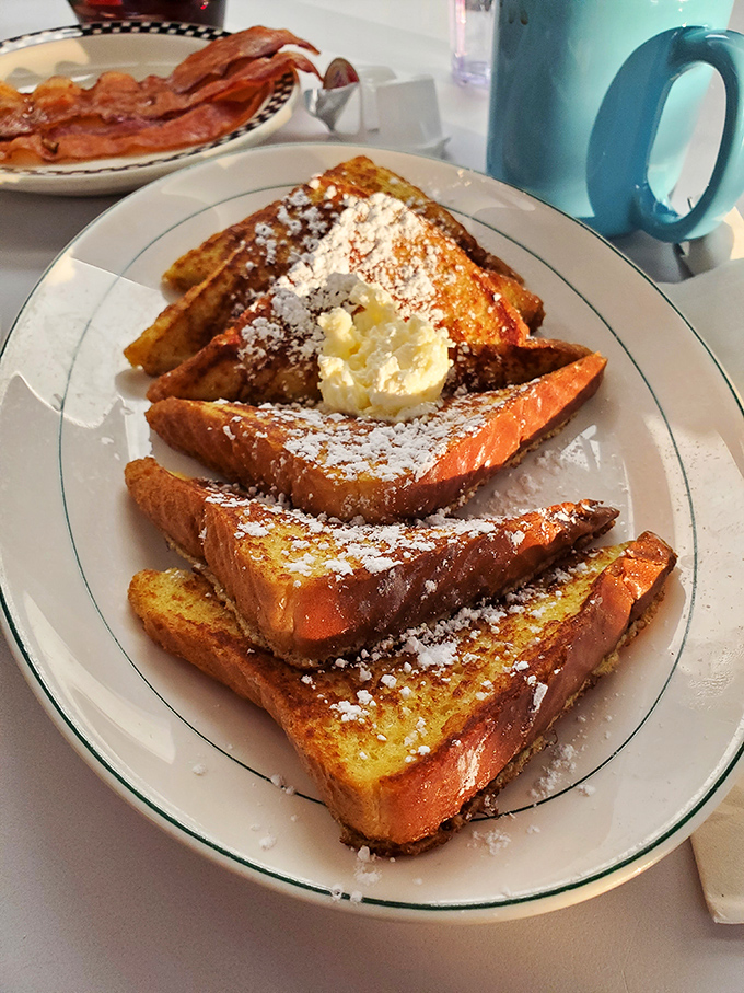 French toast that's dressed for success with powdered sugar snow and a butter hat. Whoever said "don't play with your food" never had this plate.