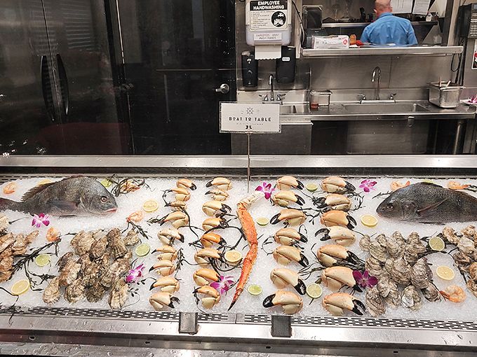 The seafood display case – where tomorrow's dinner meets today's dreams in a bed of ice adorned with edible flowers. 