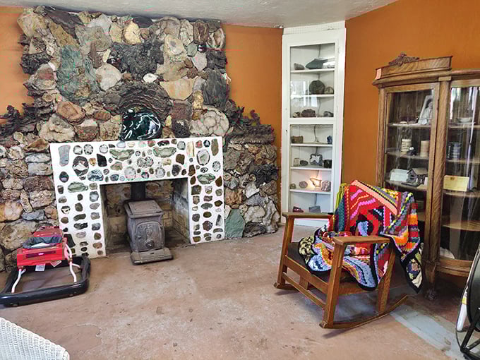 Inside the museum, even the fireplace tells a story—a cozy corner where rocks become art and a colorful afghan invites contemplation.