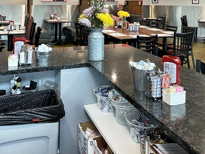 Fresh flowers in metal containers add homey touches to the counter area – small details that make a big difference.