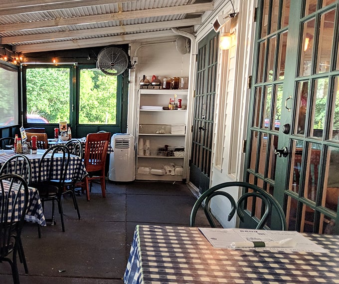 The screened porch dining area offers a breezy alternative where summer meals feel like you're at a particularly delicious family reunion.