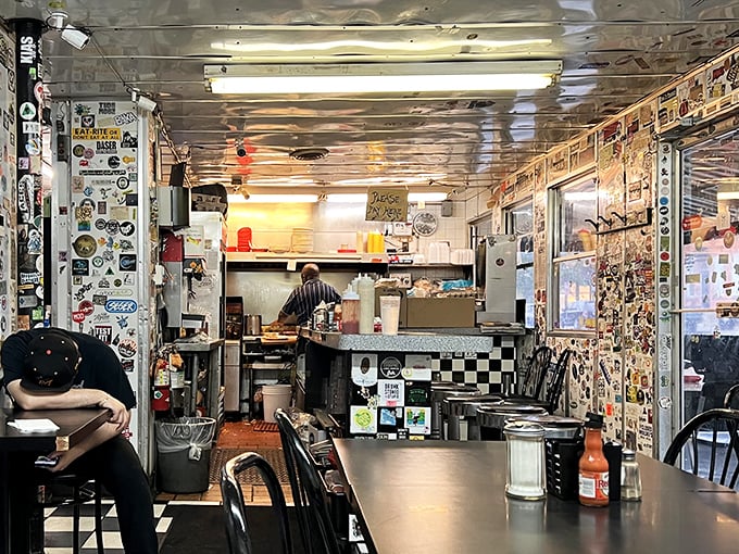 The narrow galley layout creates an intimate dining experience where conversations blend together like ingredients in the perfect omelet.