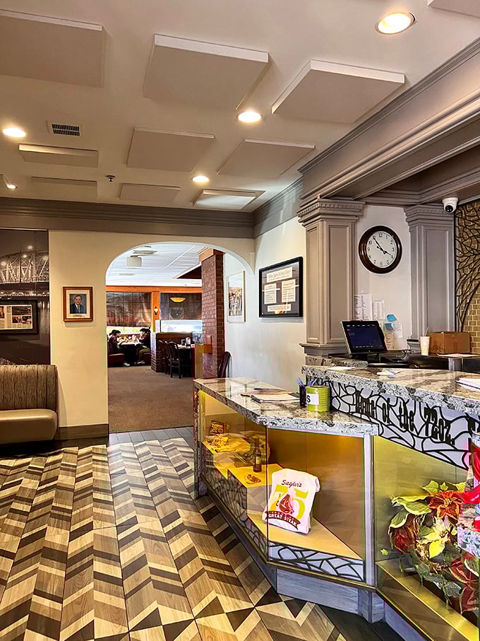 The reception area—where anticipation begins and diet plans go to die. That herringbone floor has welcomed countless hungry footsteps.