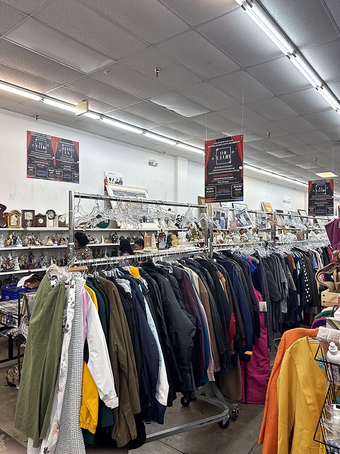 Color-coded clothing racks create a rainbow road to bargain bliss. Those red signs promise even deeper discounts—be still my thrifty heart!