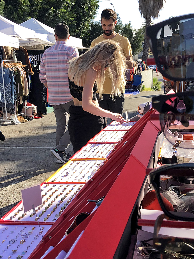 Delicate rings await new fingers to adorn, lined up like tiny sculptures that catch both sunlight and shoppers' attention.