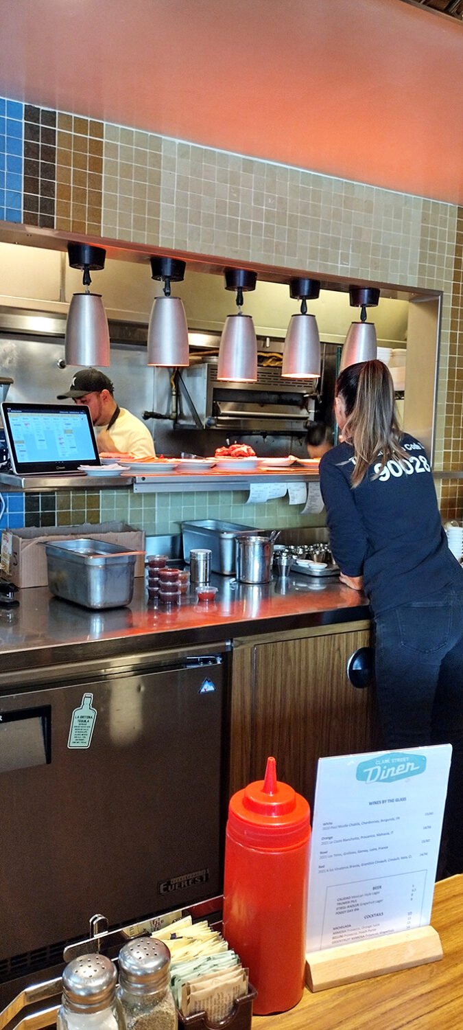 The kitchen pass – where culinary dreams become reality and servers transform into plate-balancing Olympic athletes during the breakfast rush.
