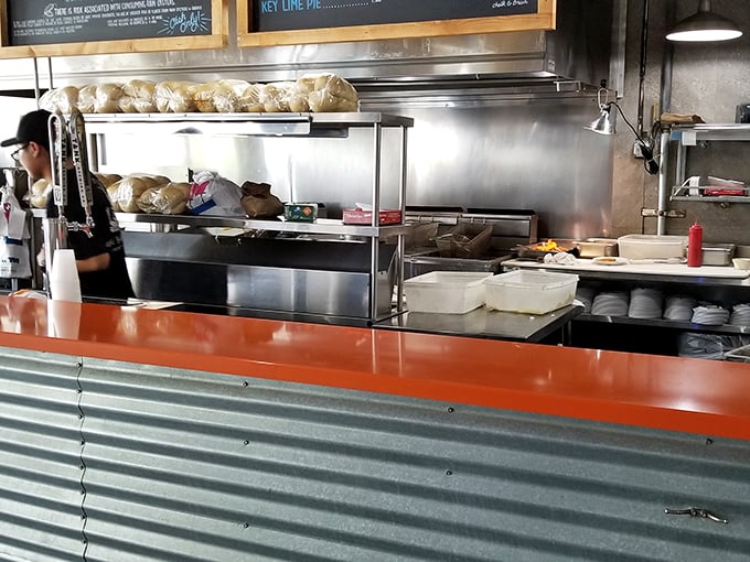 Behind the counter, where the magic happens. Those Cuban rolls aren't stacking themselves, folks – they're waiting to embrace some perfectly fried fish.