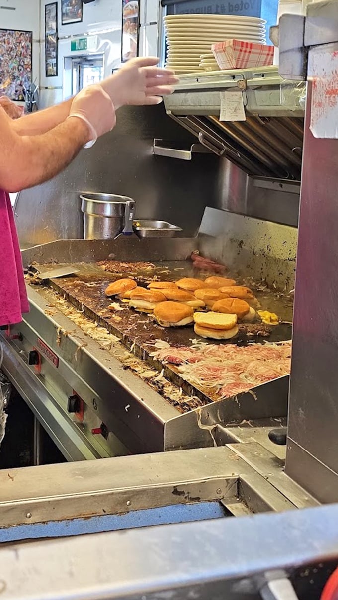 Behind the scenes where slider dreams come true—those buns steaming while patties sizzle with onions pressed right in.
