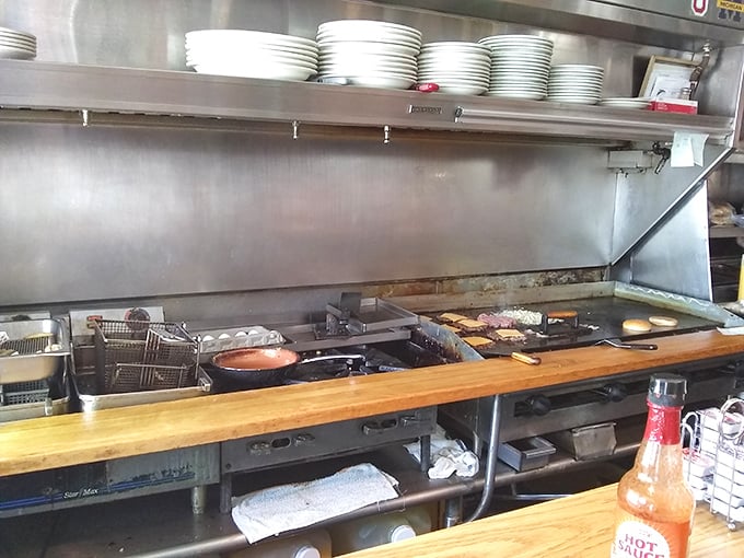 The kitchen battlefield where breakfast dreams come true—simple, efficient, and with that bottle of hot sauce standing ready for duty.