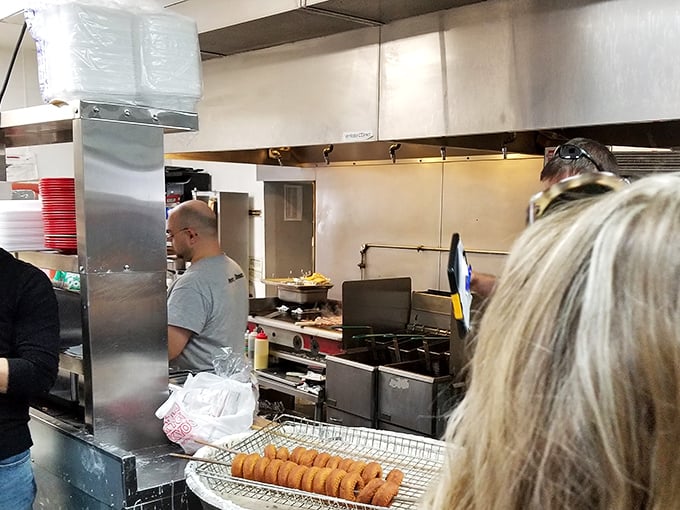 The kitchen ballet—where donuts are born in a choreographed dance of flour, sugar, and tradition.