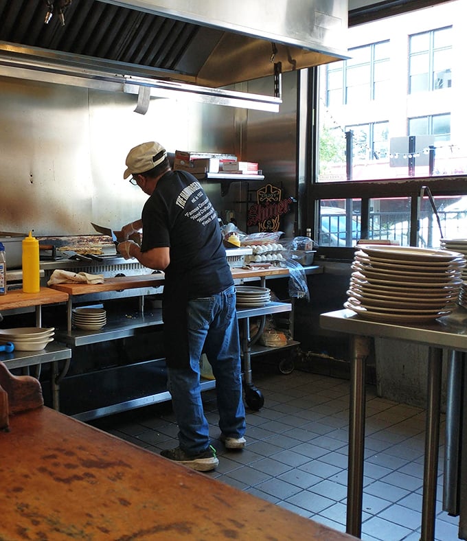 The kitchen – where morning magic happens as skilled hands prepare the comfort food classics that keep Delaware coming back.
