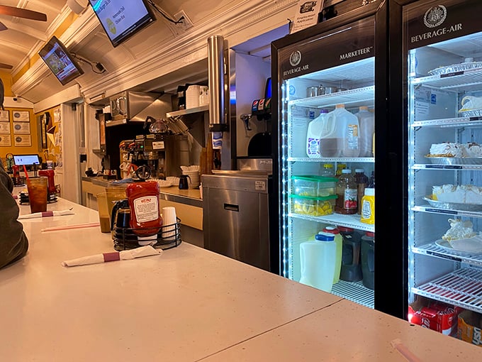 Behind-the-counter glimpse reveals the organized chaos where breakfast magic happens at lightning speed.