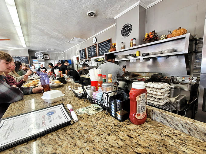 The open kitchen—where breakfast symphonies are composed in real-time. Mozart had his orchestra; Five Points has spatulas and sizzling griddles.