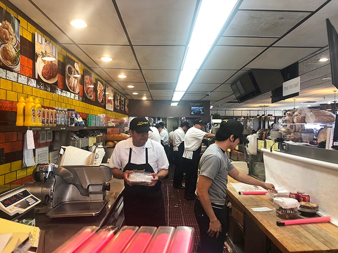 The kitchen at Langer's moves with the precision of a ballet and the urgency of a newsroom. This is where the magic happens.