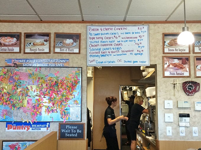 The wall map where diners proudly pin their hometowns—proving that good breakfast is worth traveling for, no passport required.