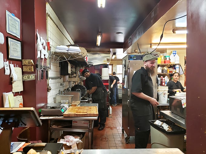 Where the magic happens—the kitchen crew orchestrating a smoky ballet that transforms raw ingredients into barbecue masterpieces.