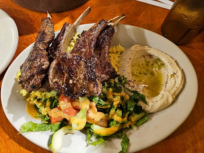 These lamb chops aren't just dinner—they're edible exclamation points, perfectly charred and resting on a bed of vegetables that refuse to be mere sidekicks.