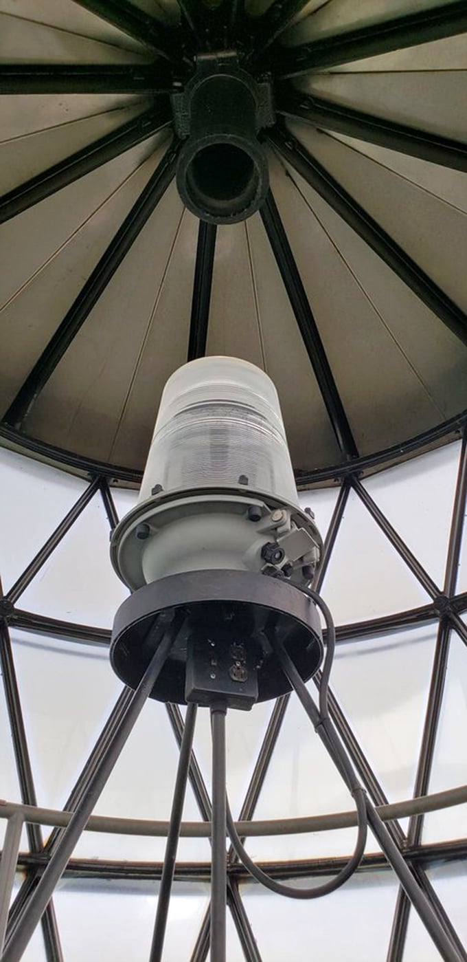 Looking up at the lighthouse lamp is like staring at the mechanical heart of maritime safety—both beautiful and purposeful.