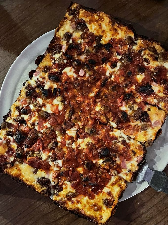 A meat lover's pizza so generous it should come with its own cardiologist's business card—worth every delicious risk.