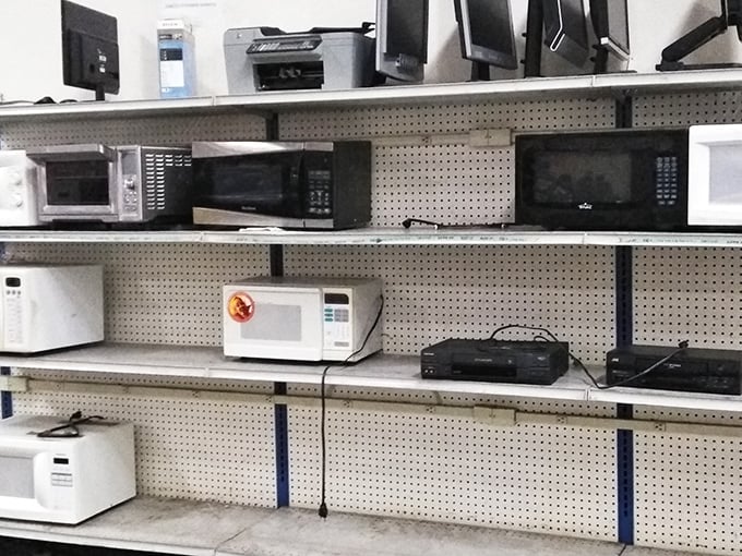 Microwave row—where kitchen appliances line up like hopeful contestants on a dating show, each one ready to heat up someone's leftovers with dignity.
