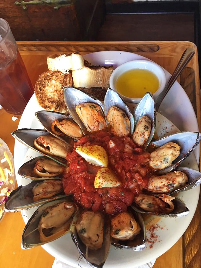 These mussels aren't just opened—they're practically performing a synchronized swimming routine in that spicy tomato bath.